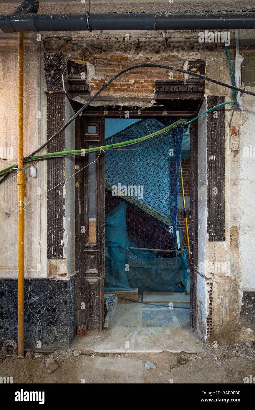 A historic building entrance under renovation, showing exposed bricks ...
