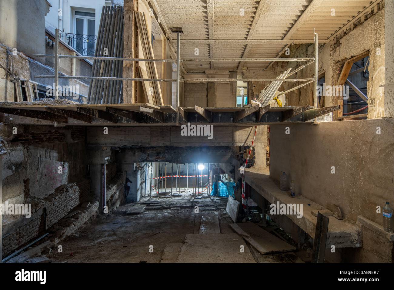 A construction site inside a partially renovated building features an ...