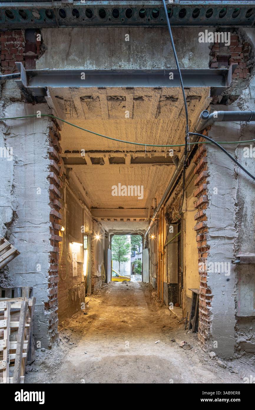 A construction site featuring a partially demolished entrance with ...