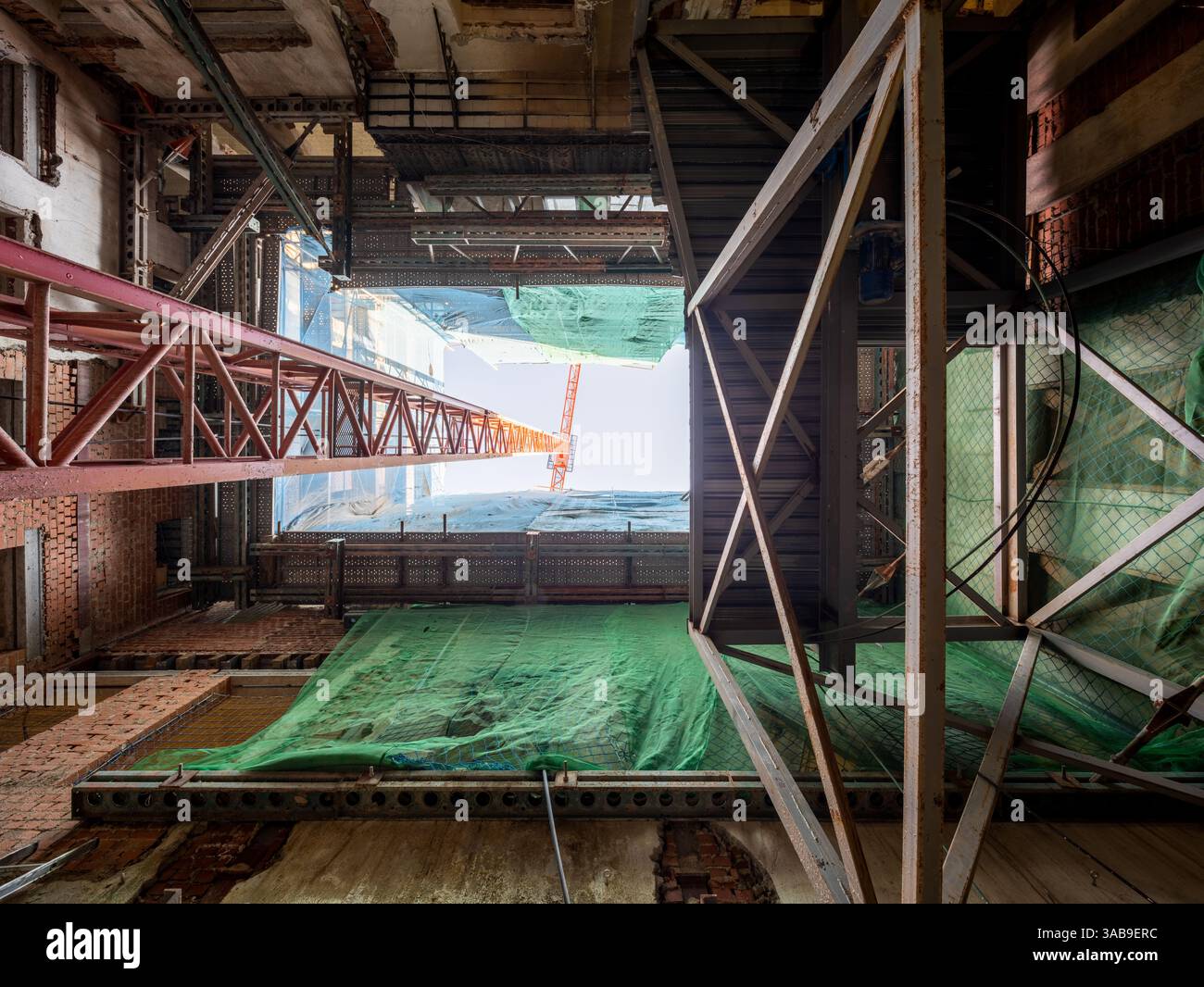 Looking up inside a building under construction, steel beams ...