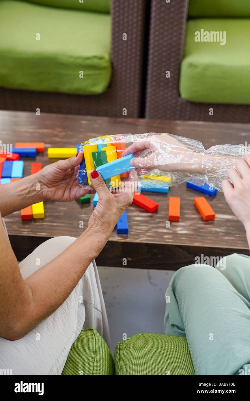 A mother and daughter are engaged in a colorful board game, fostering ...