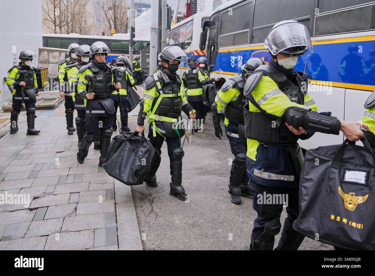 South Korean police officers wearing their protective equipment walk ...