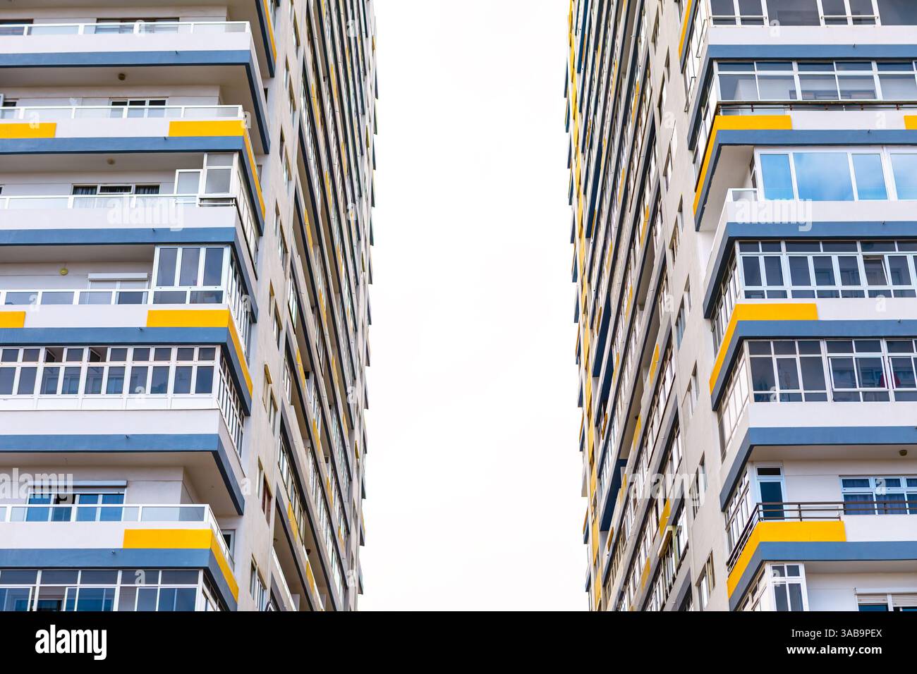 Two contemporary apartment buildings showcasing a blend of white, blue ...