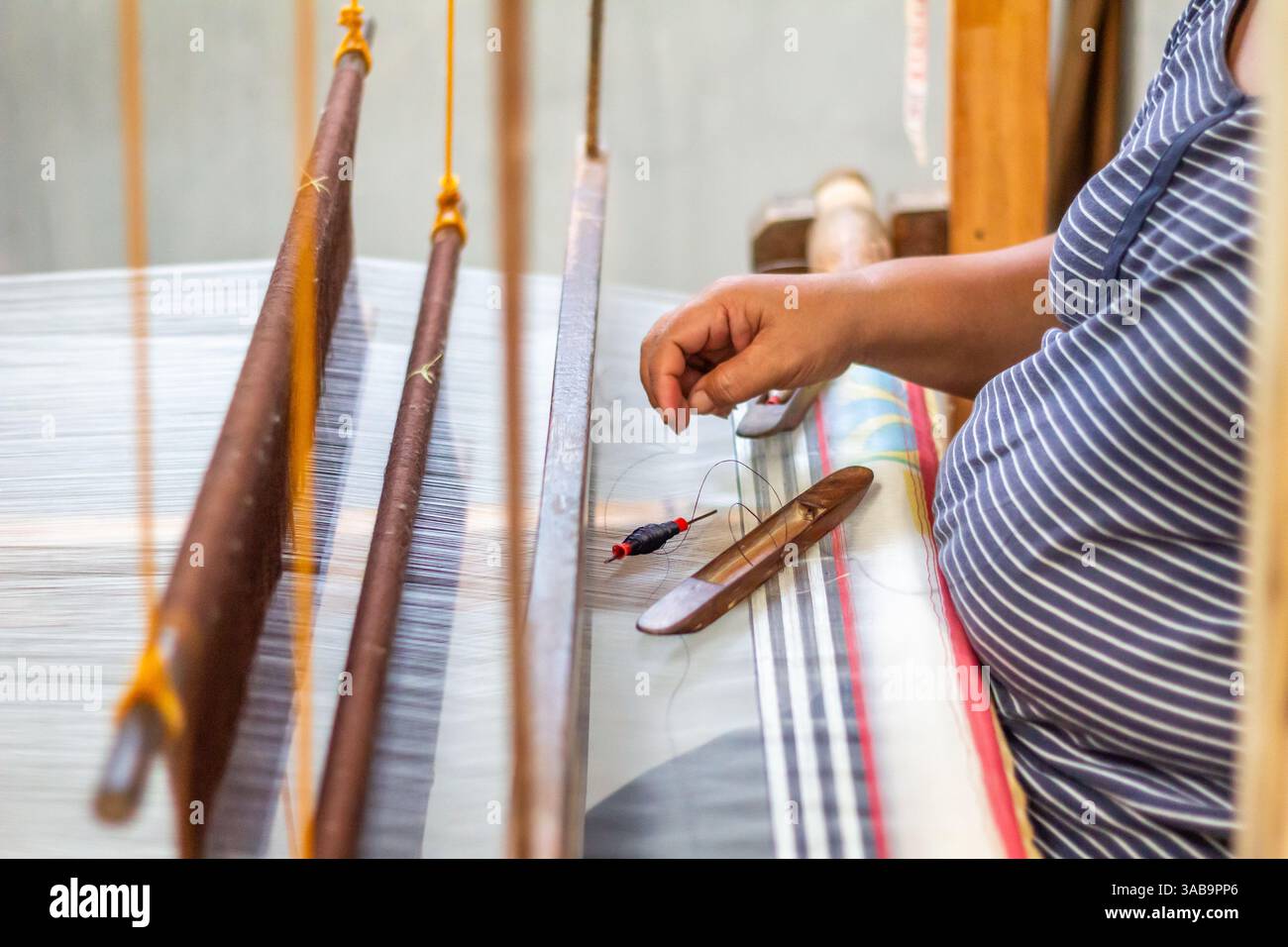 Piña fiber weaving on a wooden mechanical loom in Aklan, Philippines, a ...