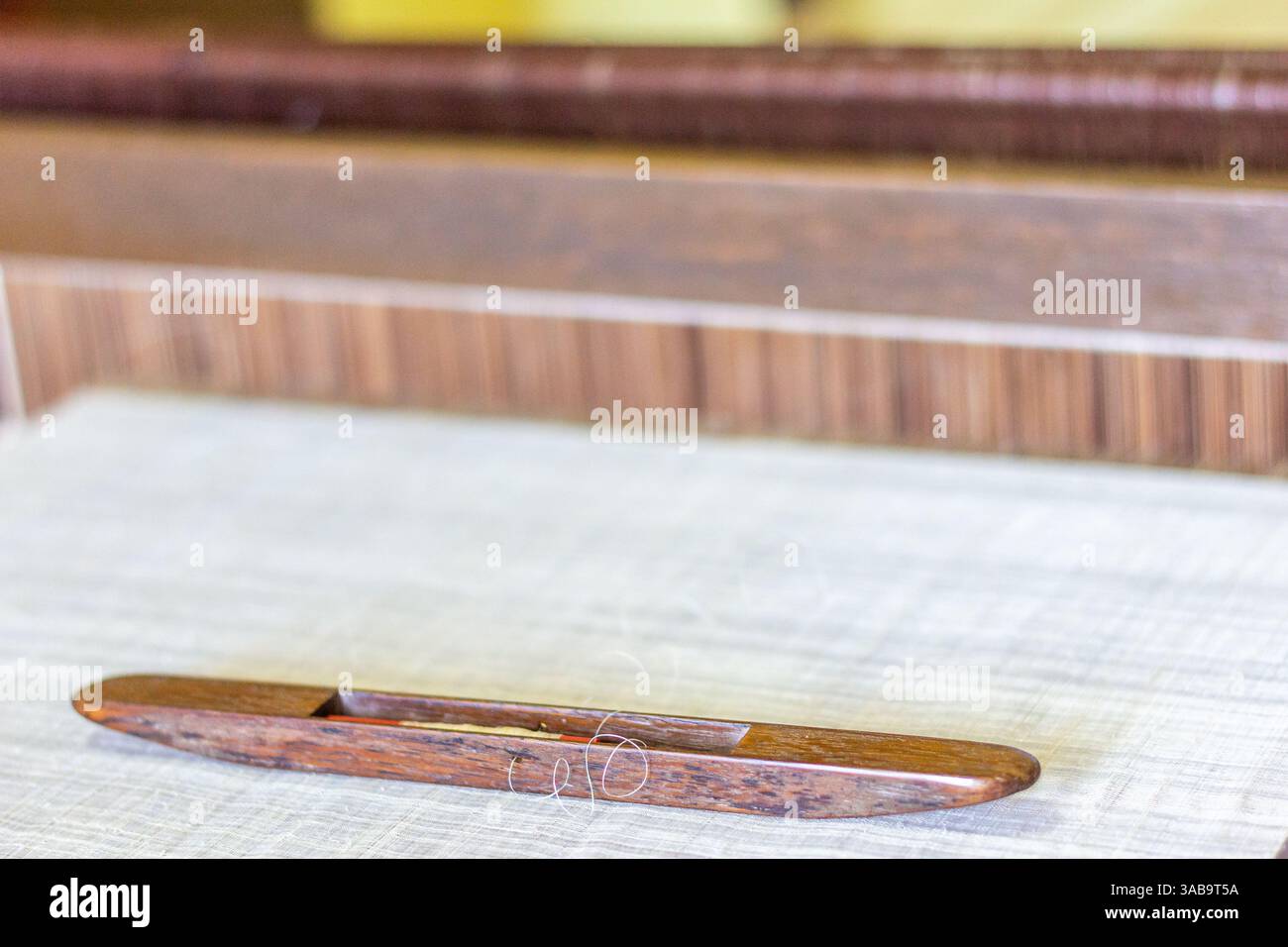 Piña fiber weaving on a wooden mechanical loom in Aklan, Philippines, a ...