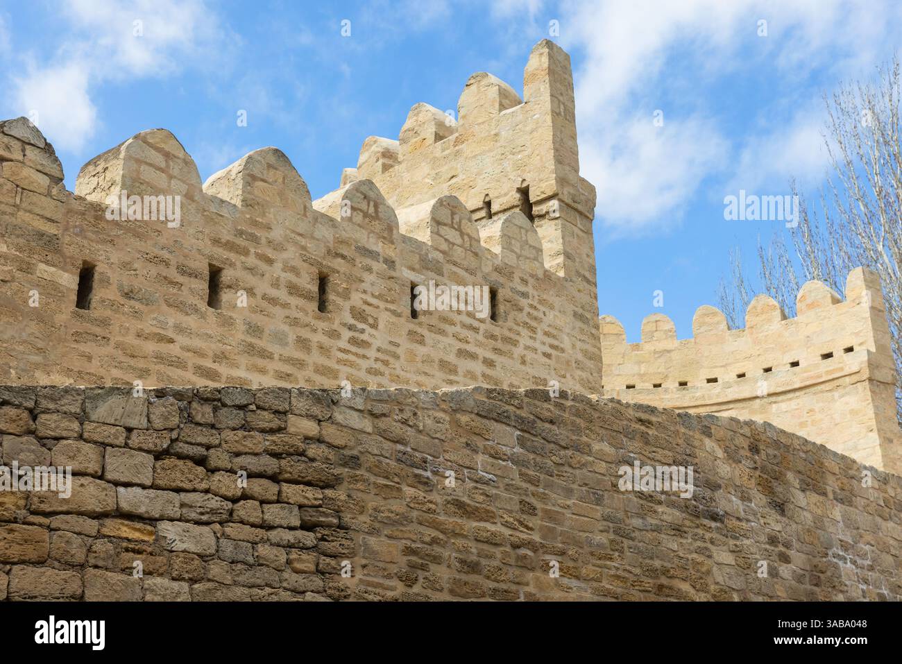 Historic stone fortification walls are under a vivid blue sky with ...