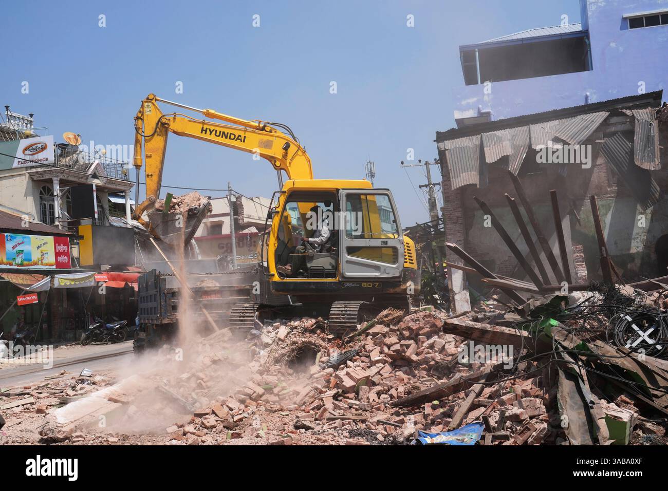 Rescuers clean debris from damaged buildings in the aftermath of Friday ...