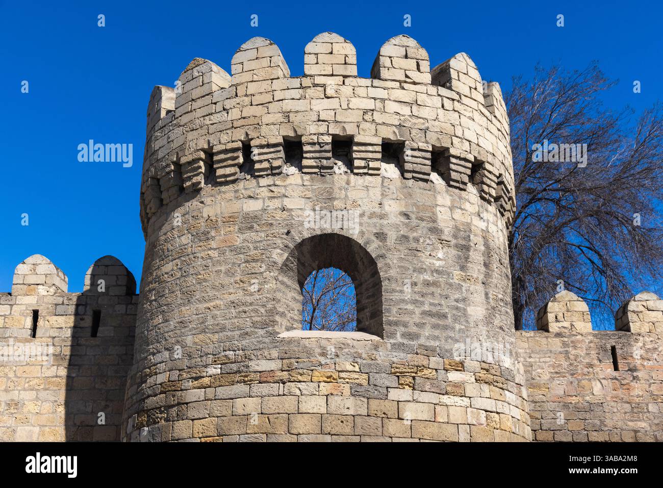 A historic stone tower with battlements, part of a castle wall, under a ...