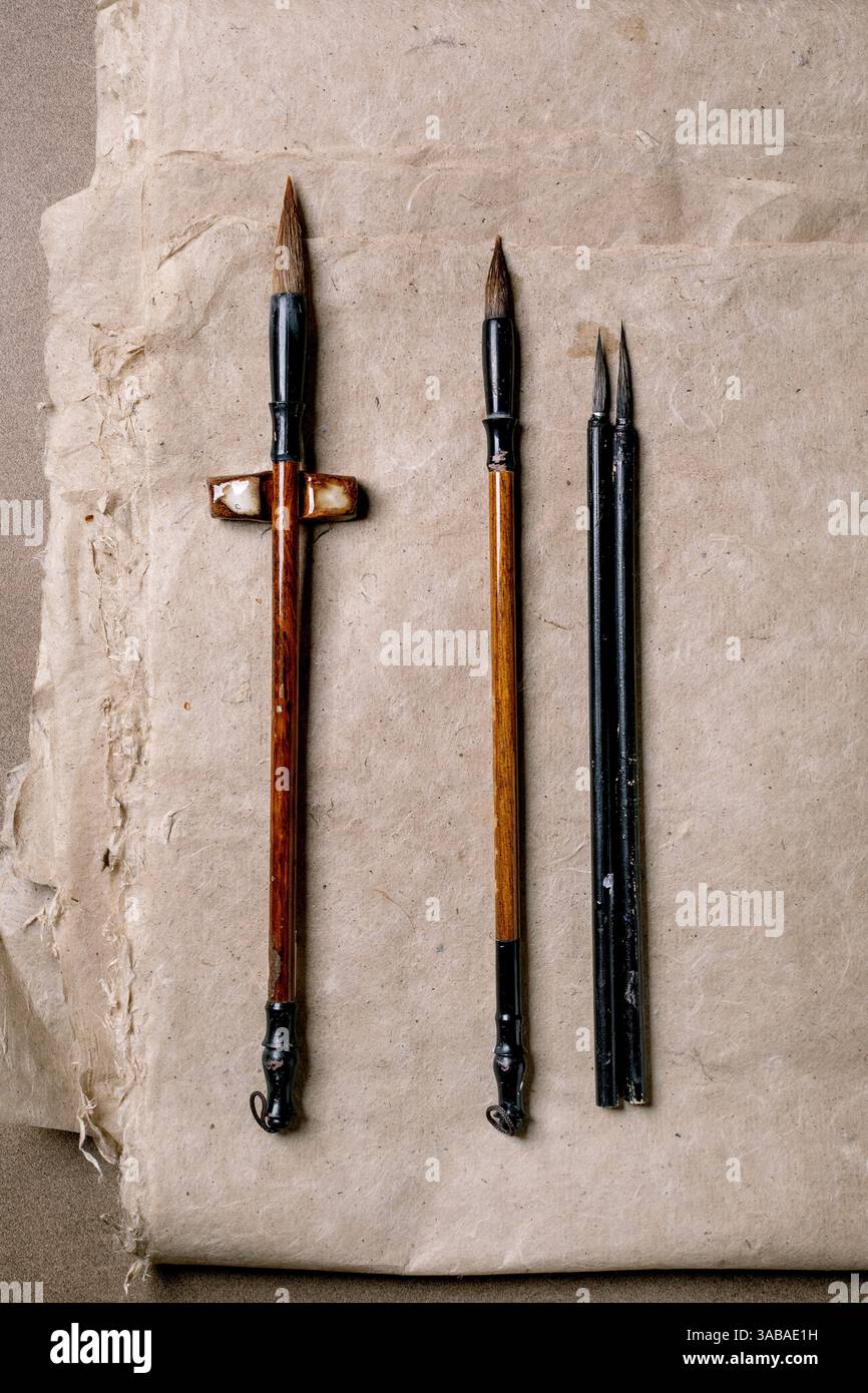 Traditional Chinese calligraphy brushes with wooden handles on aged ...