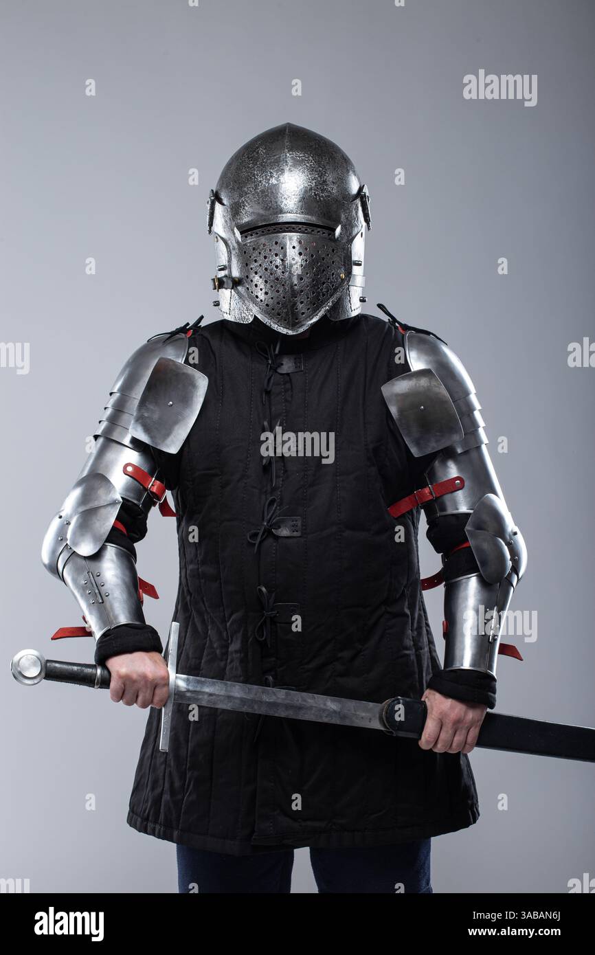 Knight in Full Plate Armor Holding a Sword. This image shows a person ...
