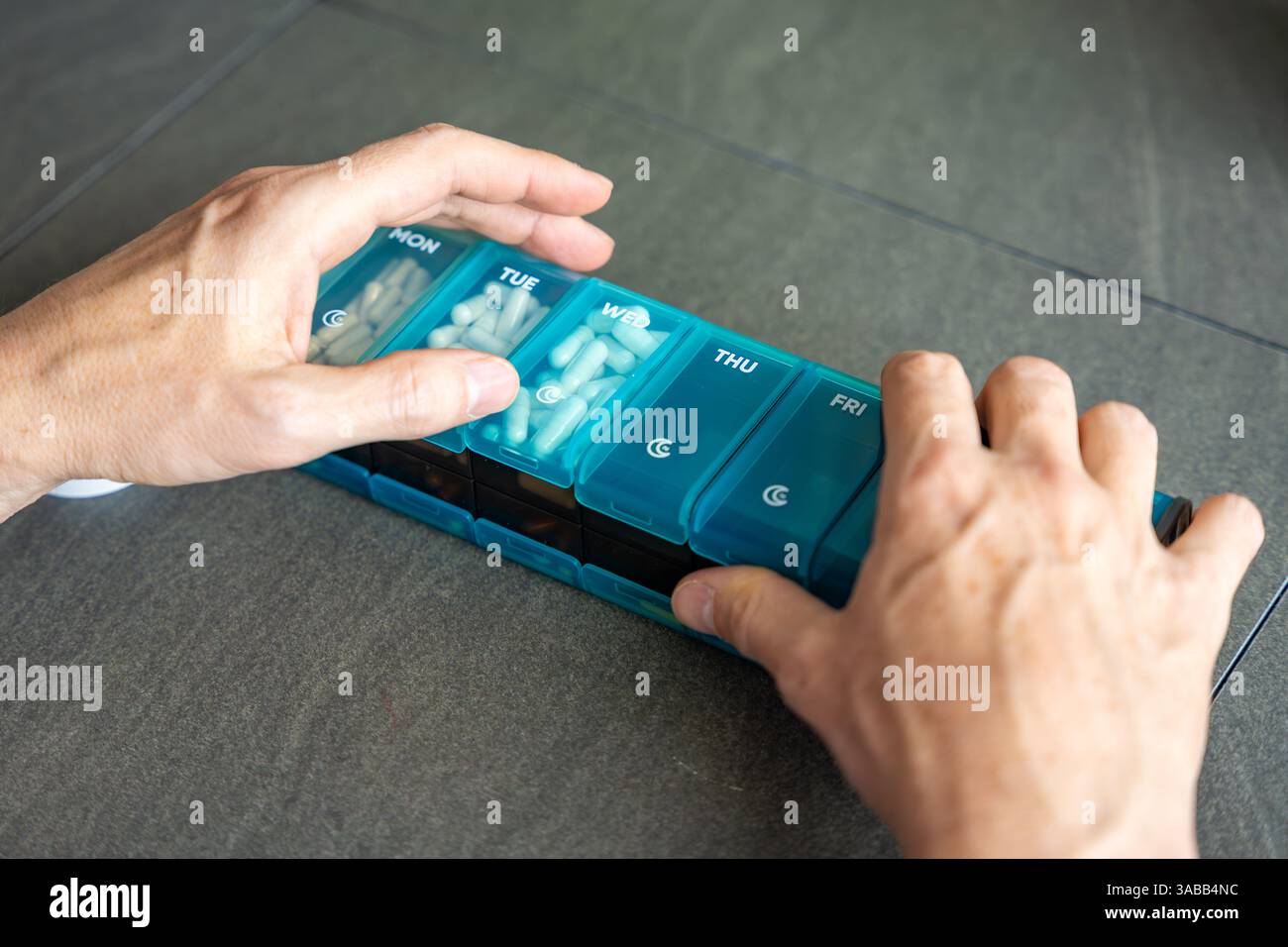 Weekly pill organizer with labeled compartments for daily medication ...