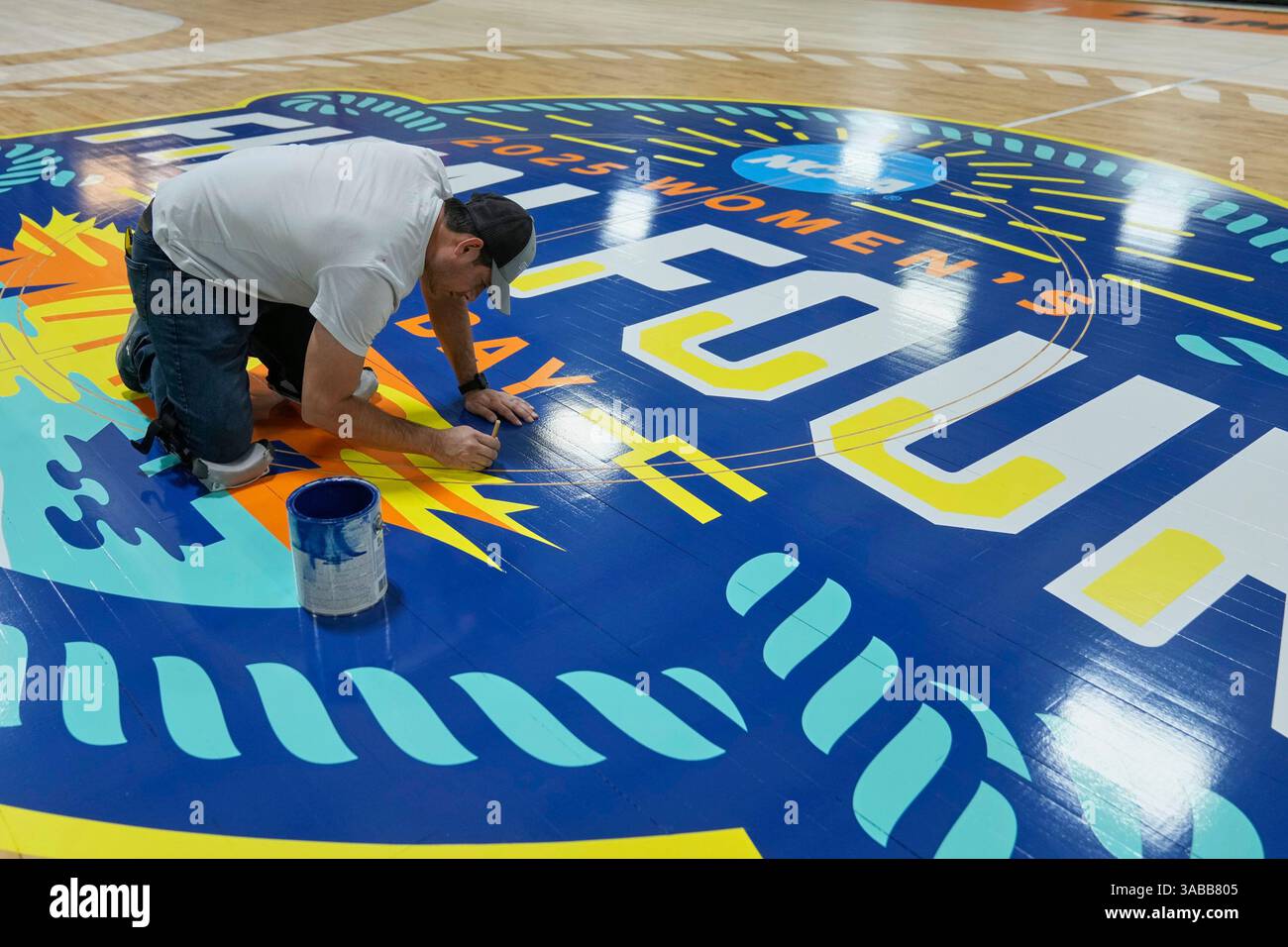Nixson Jarquin touches up the paint on the court for the Final Four in ...