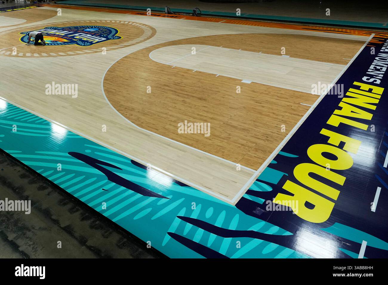 Nixson Jarquin touches up the paint on the court for the 2025 Women's ...