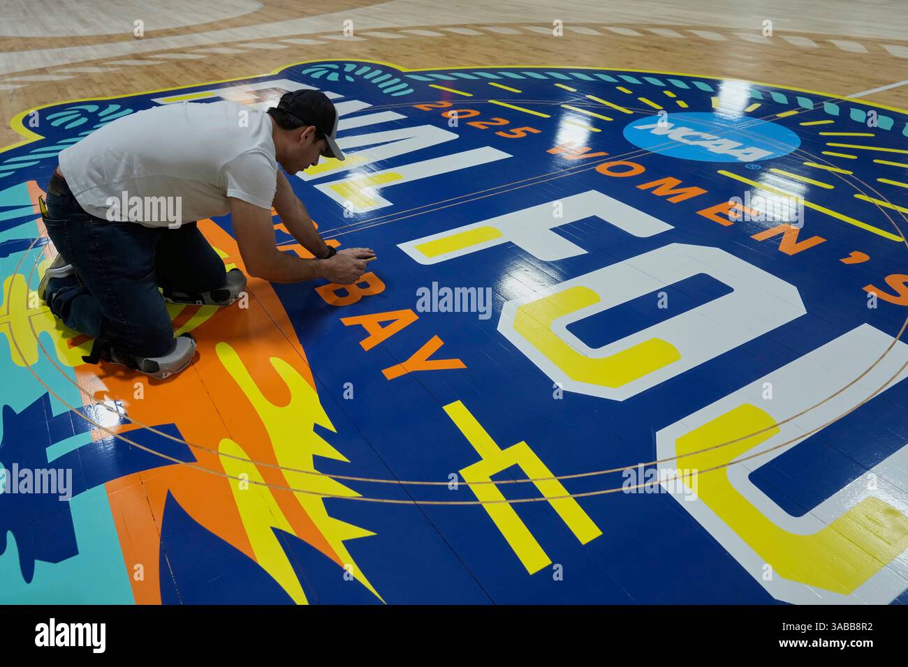 Nixson Jarquin touches up the paint on the court for the 2025 Women's ...