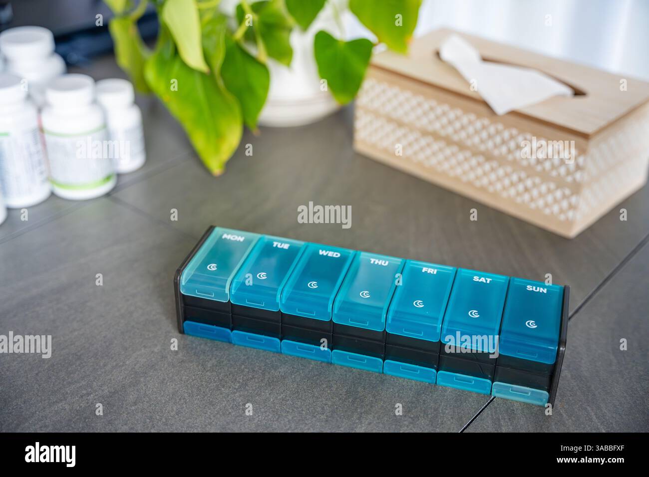 Weekly pill organizer with labeled compartments for daily medication ...