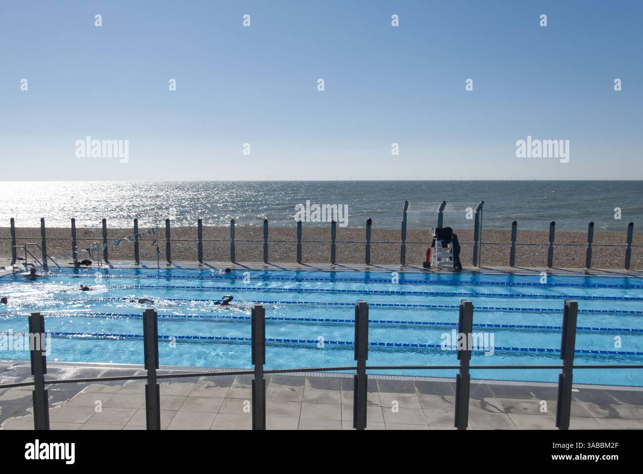 Open air swimming pool on Brighton Beach, East Sussex, England. With ...
