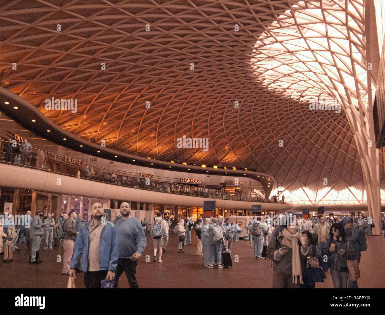 Interior of King's Cross train station with lattice steel roof and ...
