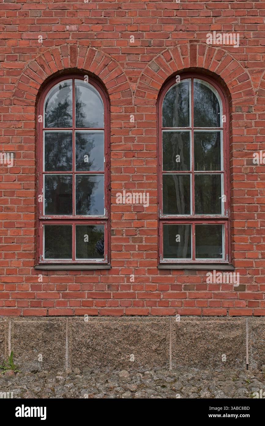 Old brown framed windows with arch on red brick wall Stock Photo - Alamy
