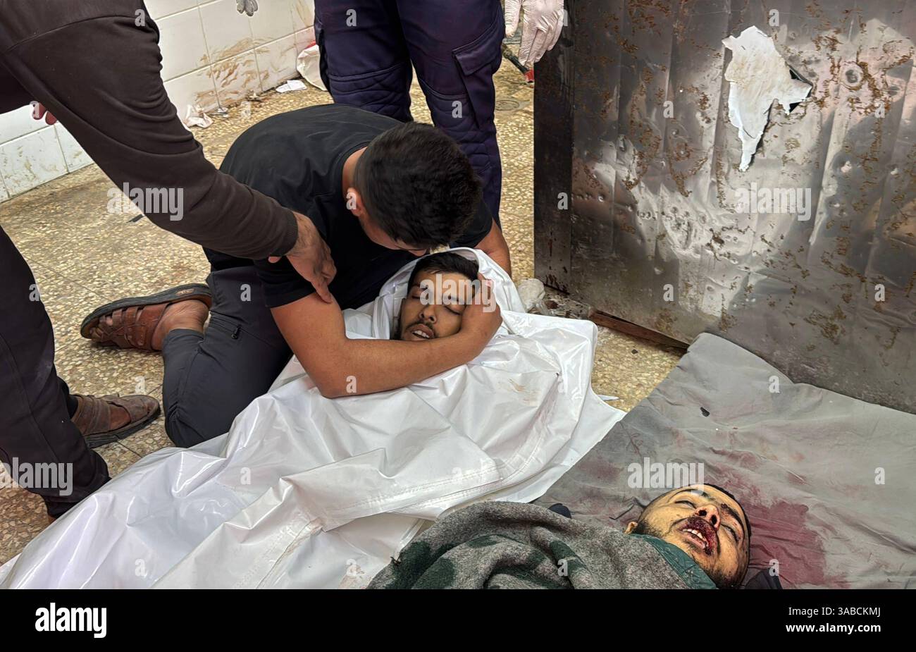 Bodies of Palestinians are brought to the Al-Aqsa Martyrs Hospital by their relatives Bodies of ...