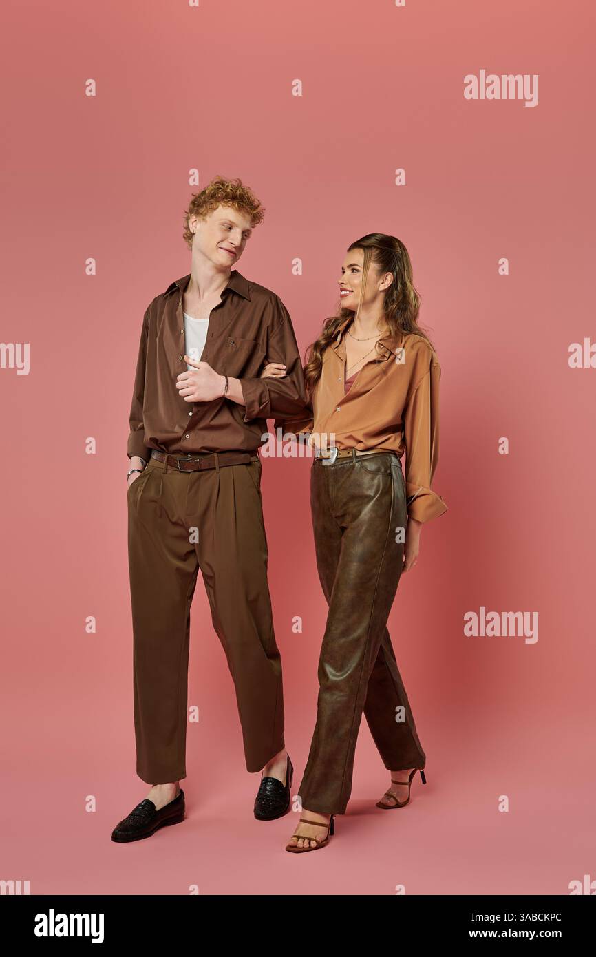 Amorous couple shares a joyful connection while dressed in trendy ...
