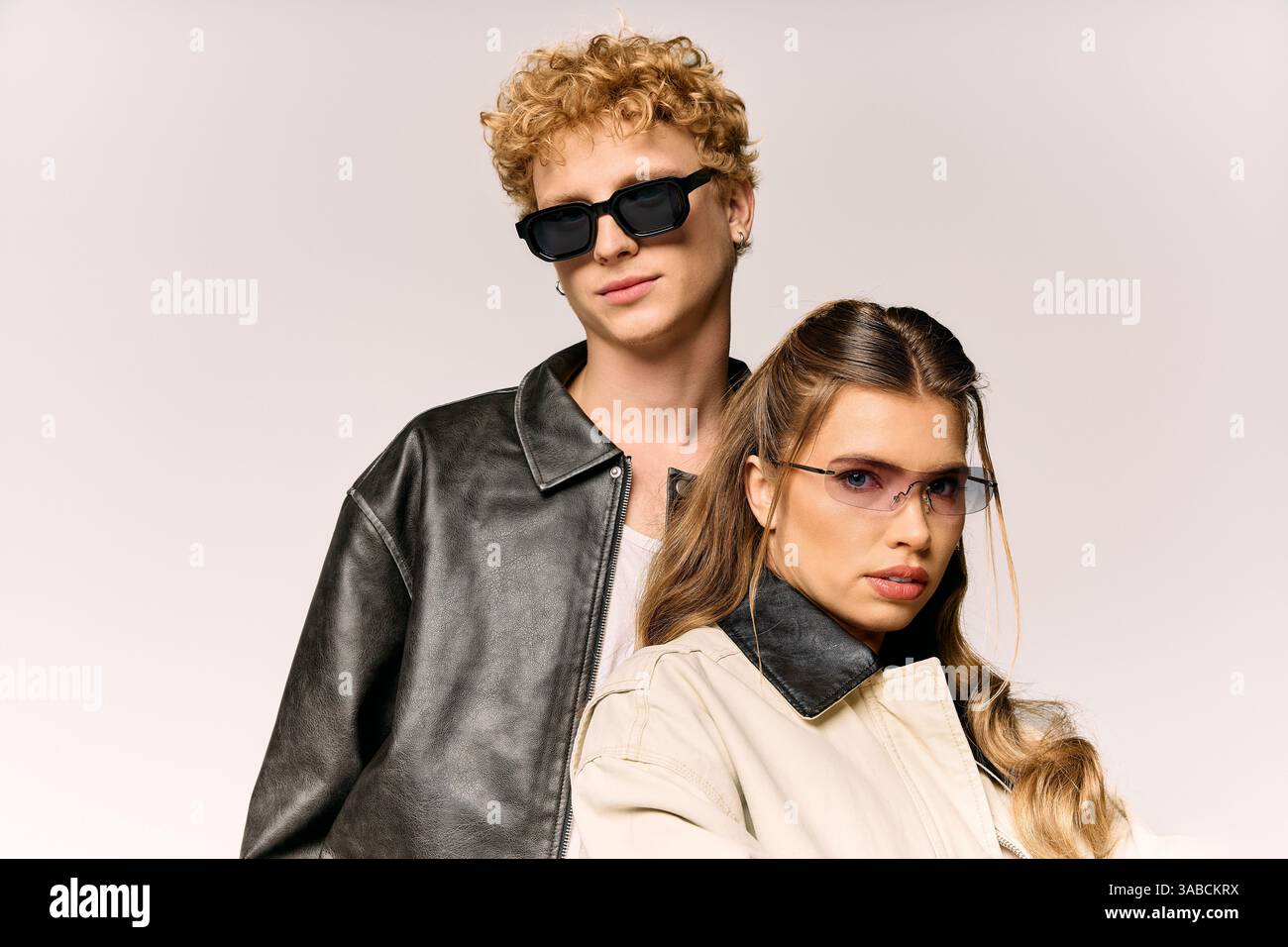 Loving couple embraces in stylish outfits, enjoying a joyful moment ...