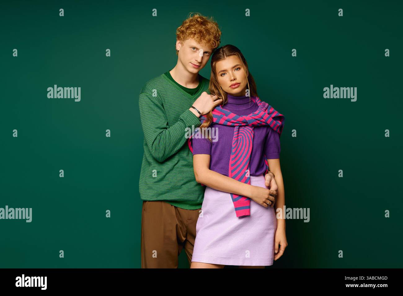 A young couple showcases their style and affection while posing ...