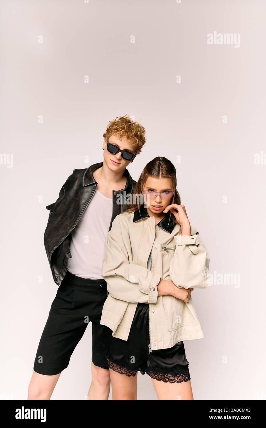 Young couple in vibrant attire stands together, expressing romance and ...