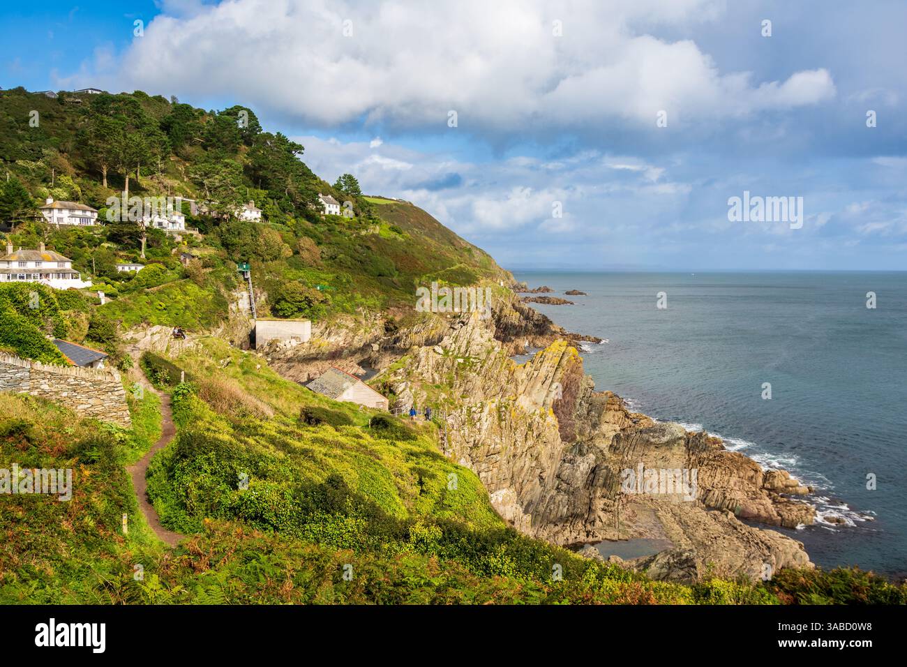 A scenic coastal pathway winds through the lush cliffs of Polperro ...