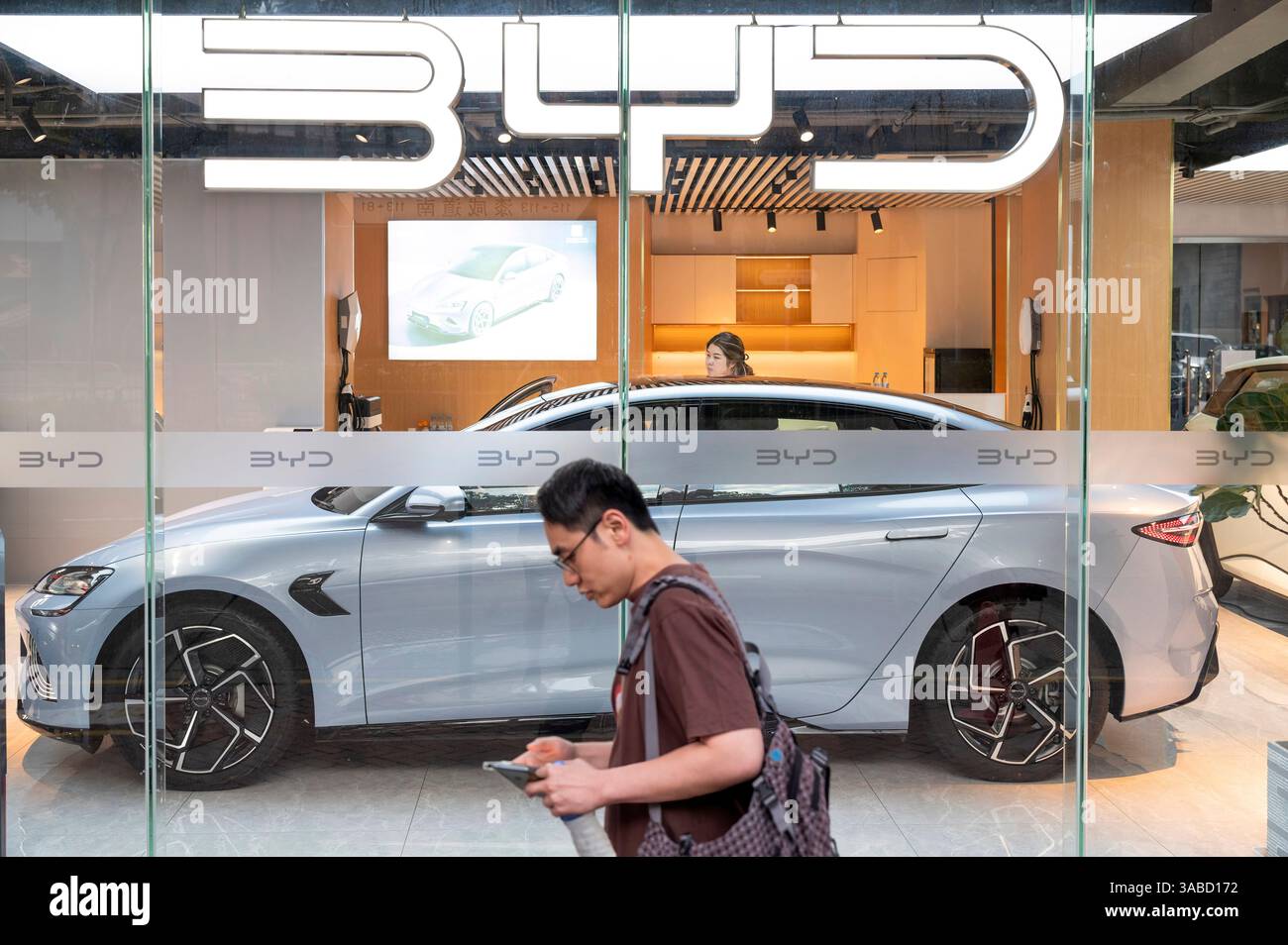 A pedestrian walks past the Chinese automaker BYD official authorized car dealer store in Hong ...