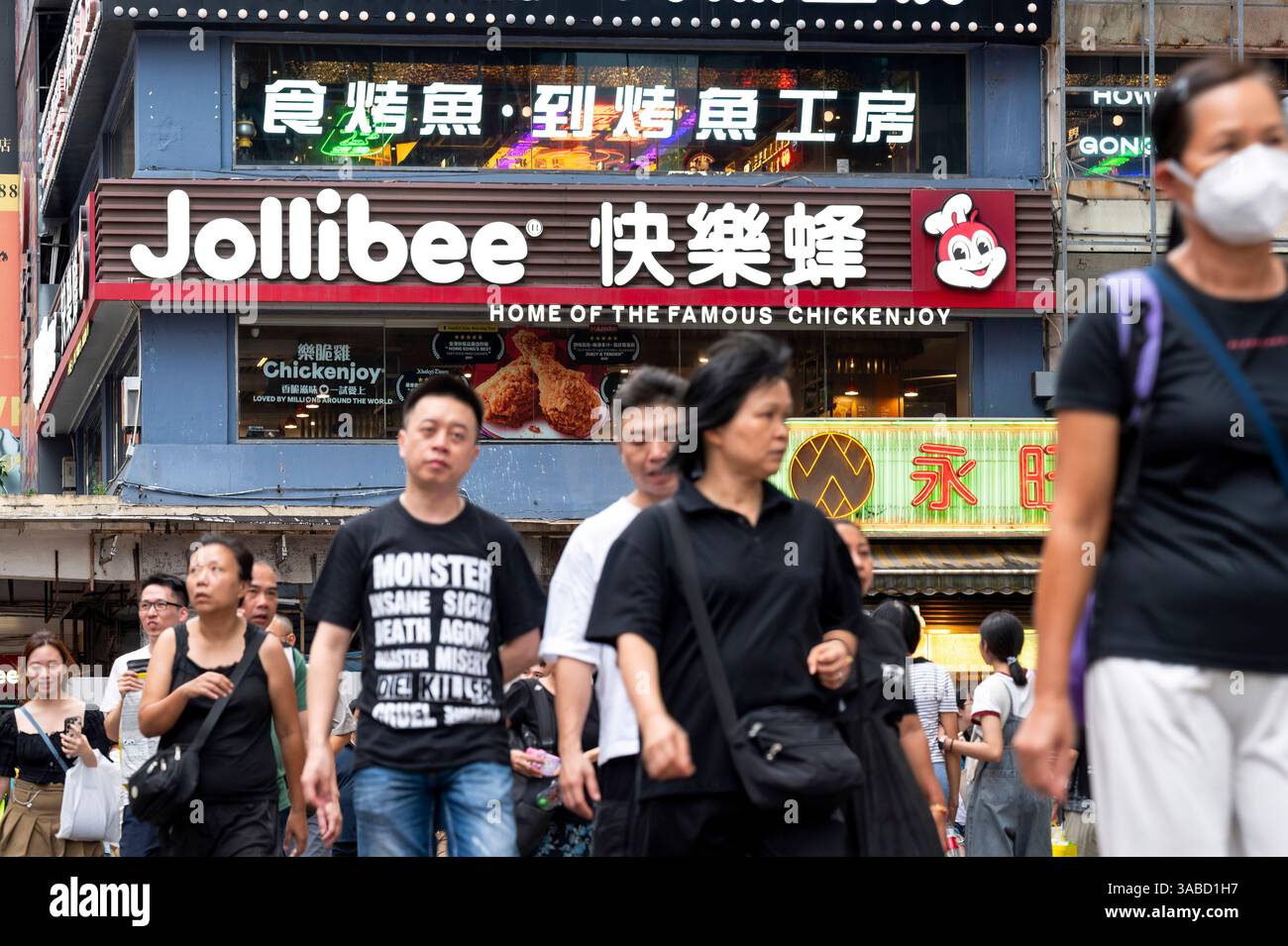 Pedestrians walk past the Filipino multinational chain of fast food ...