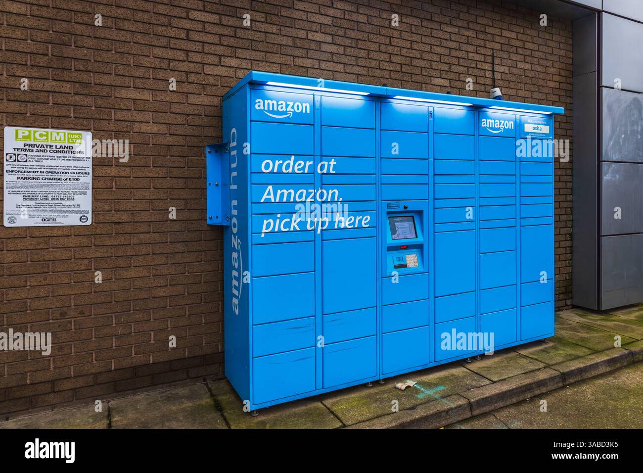 Amazon Locker pickup station on brick wall for parcel collection ...