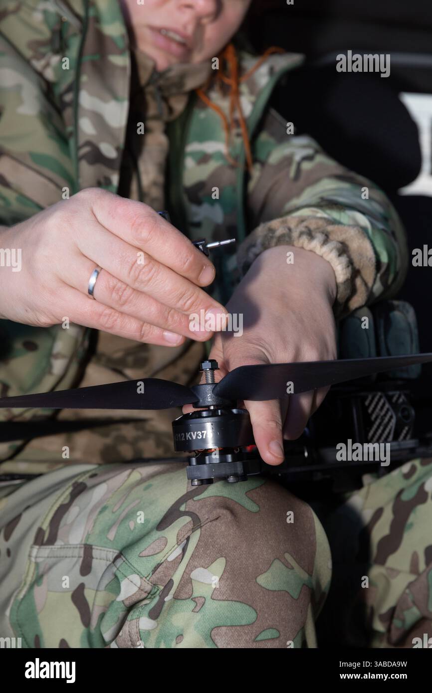 A female UAV operator is seen assembling the drone before the test ...