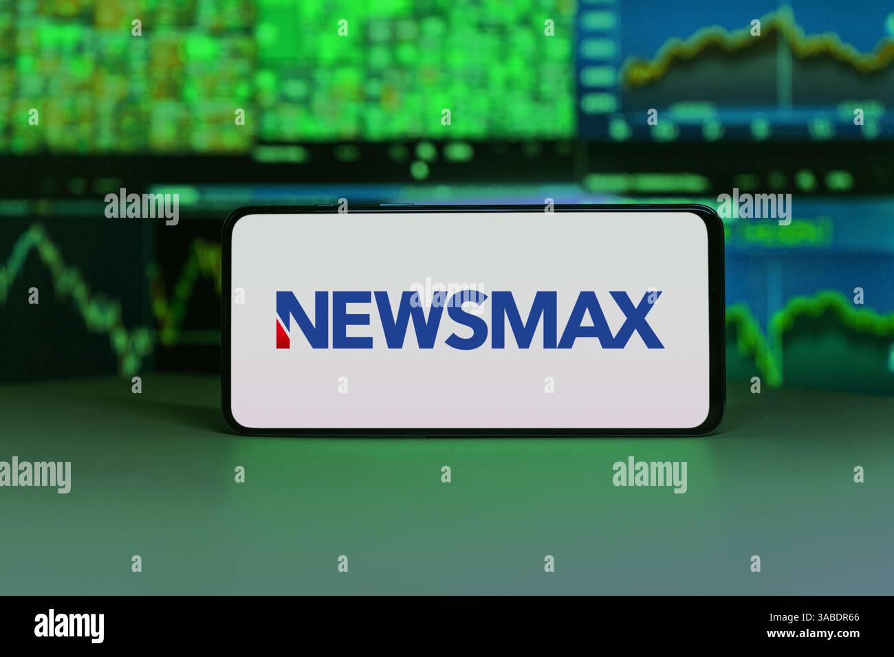 Newsmax close-up of smartphone screen displaying Newsmax logo with ...