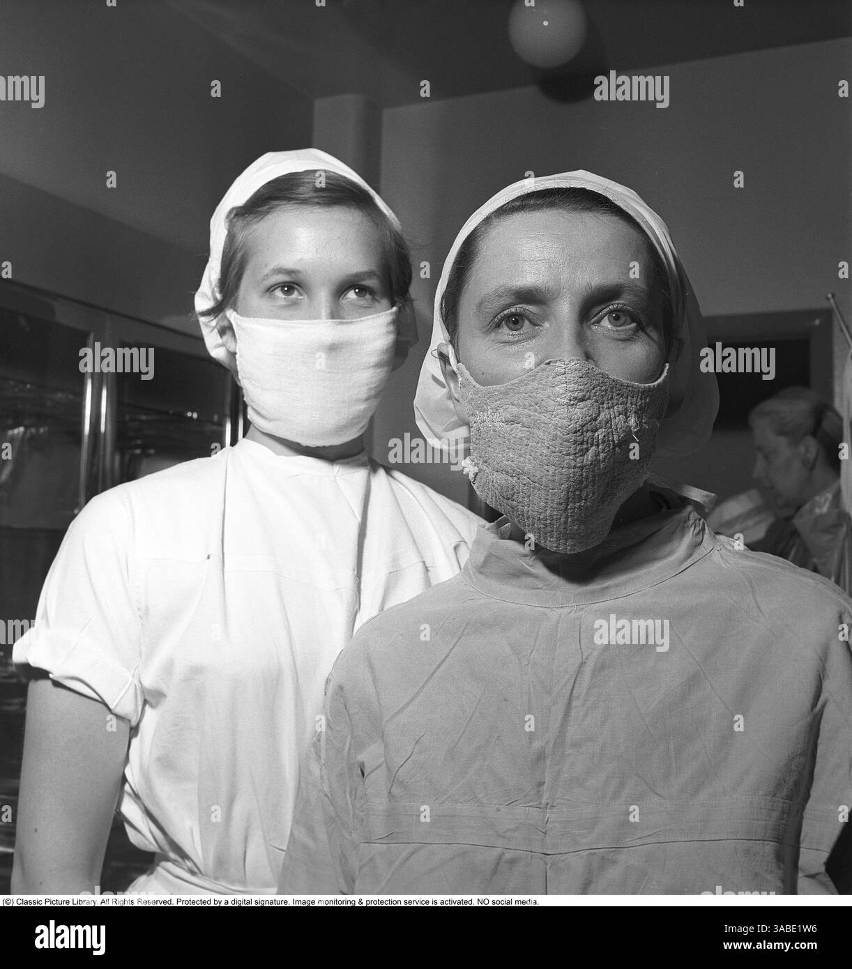 Hospital in the 1950s. Two women wearing surgical masks to help ...