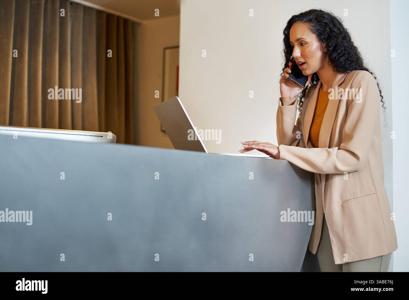 Professional Receptionist in a Modern Hotel Lobby Assisting a Guest ...