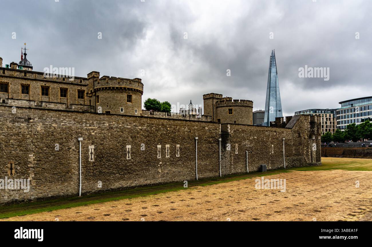 The ancient walls of the Tower of London with The Shard in the distance ...