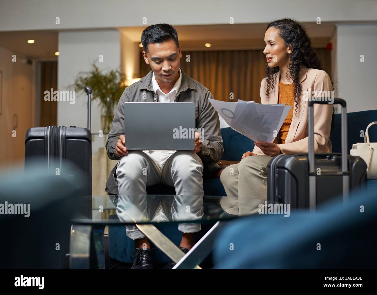 Colleagues Collaborating in a Hotel Lobby During a Business Trip with ...