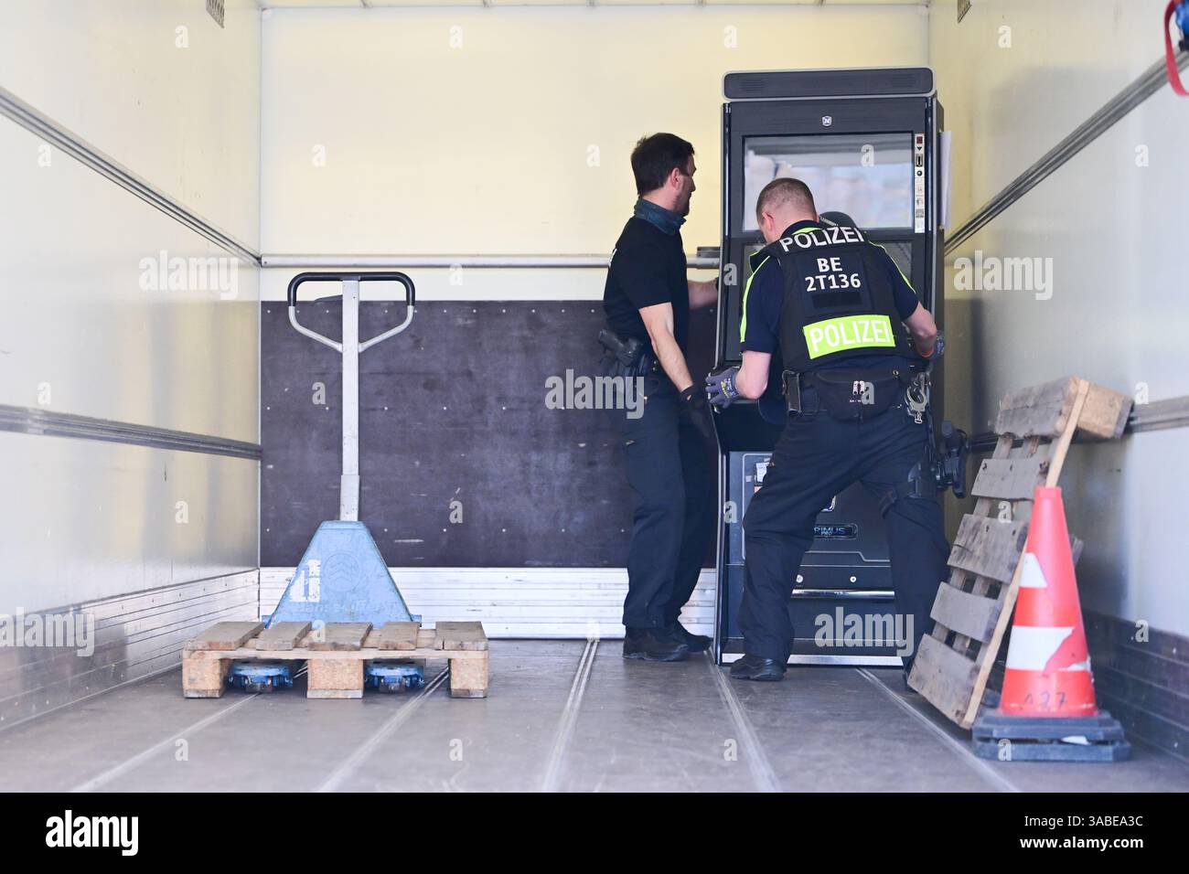 02 April 2025, Berlin: Officers remove a slot machine from a pub. The ...