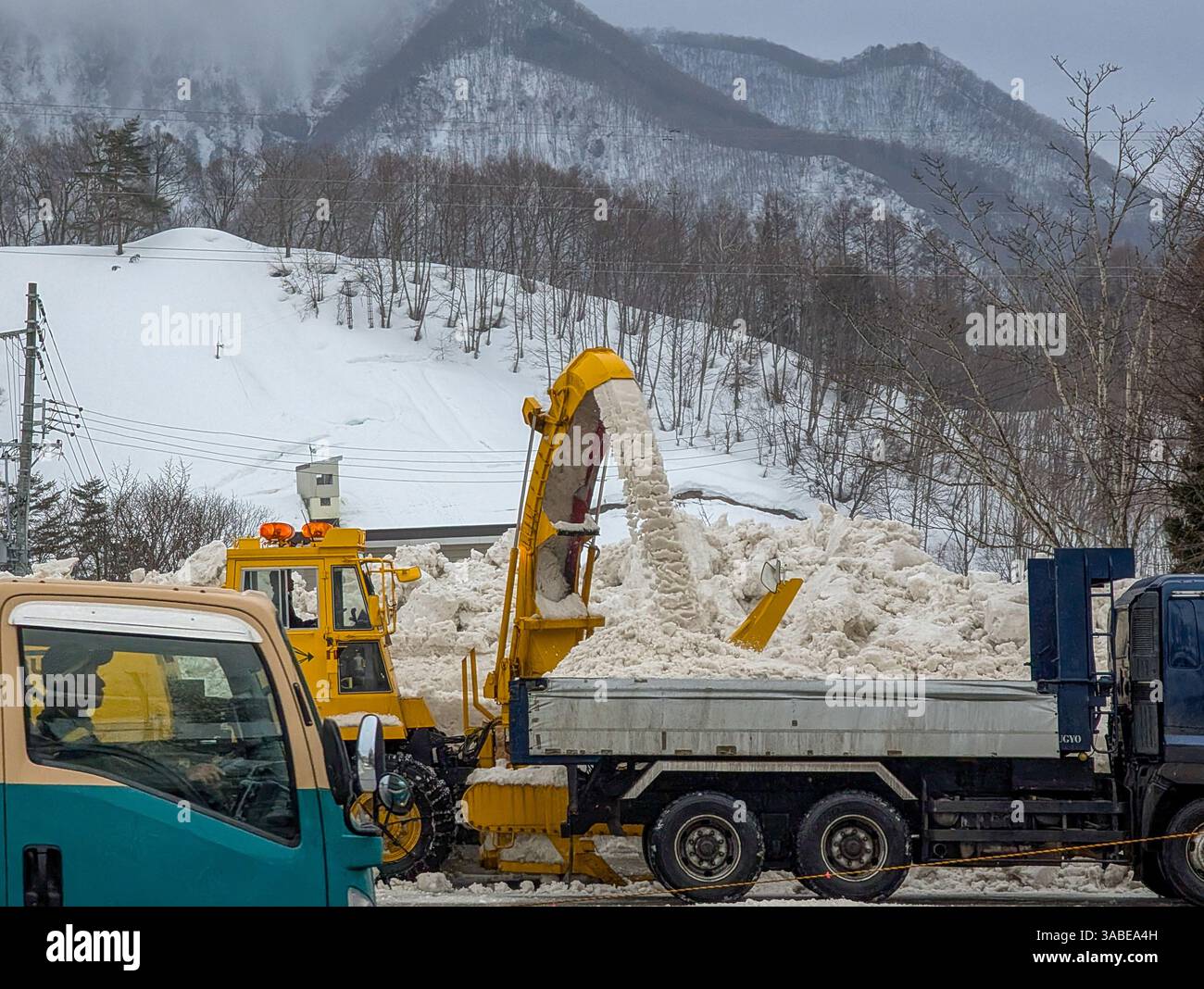 Earthmover removal snow from a roadside in Tsugaike, Nagano, Japan ...