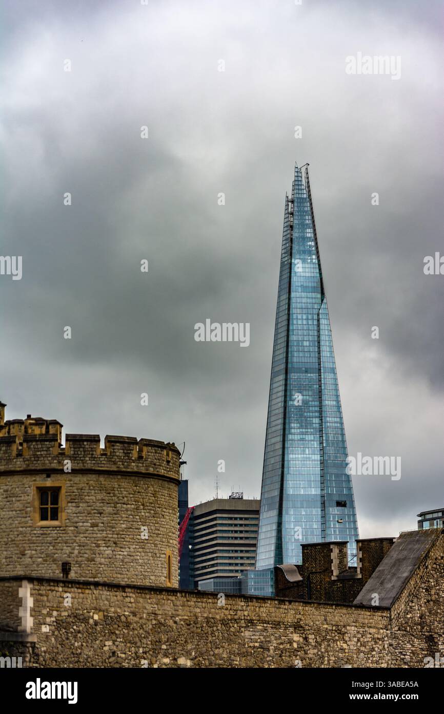 The Shard skyscraper rises above the historic Tower of London under a ...