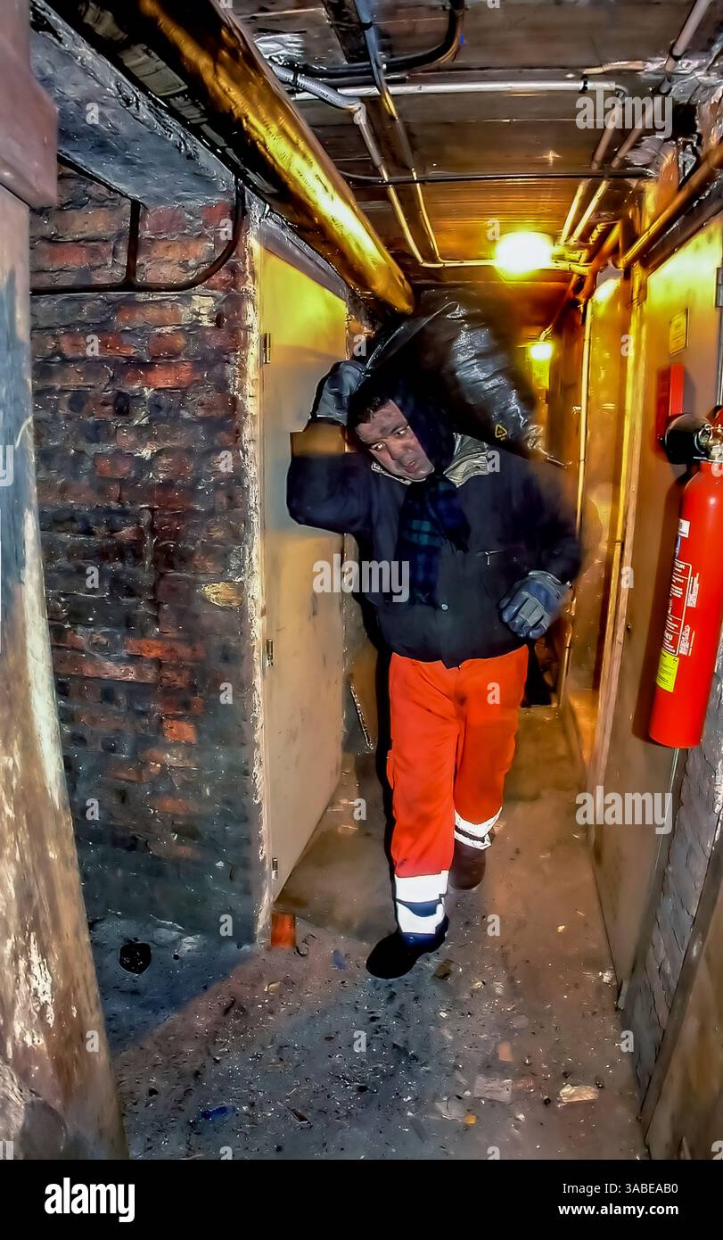 PARIS, France - Man in Cave, Holding Sack of Coal, Delivery of Coal to ...