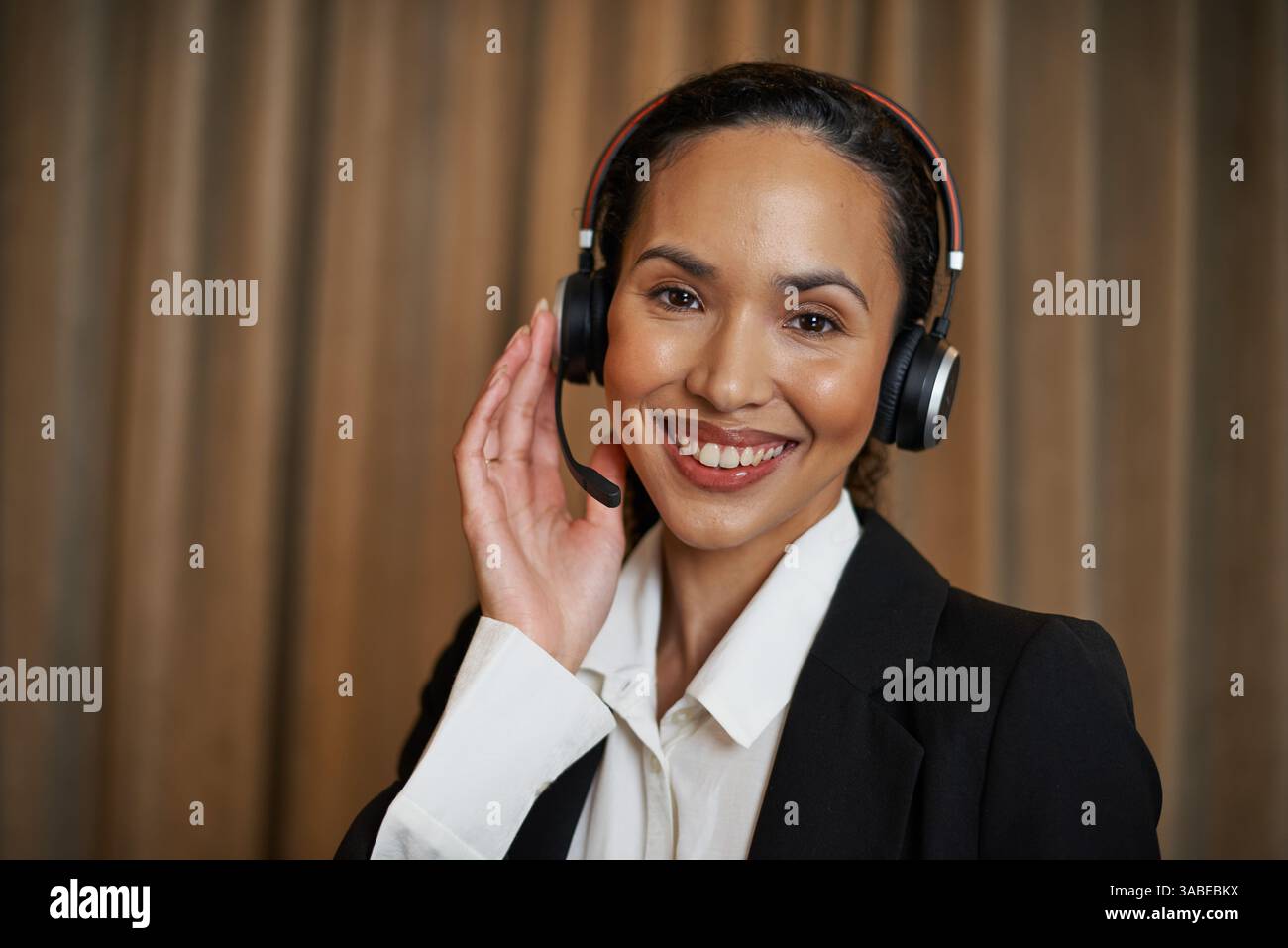 Professional Smiling Receptionist in Office Attire Using a Headset ...