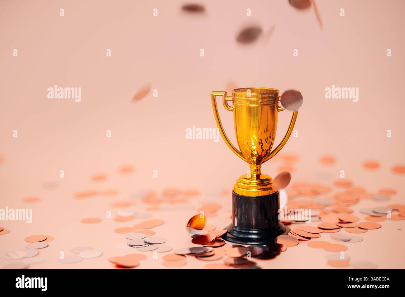 A winner's cup surrounded by flying shiny confetti, symbolizing victory ...