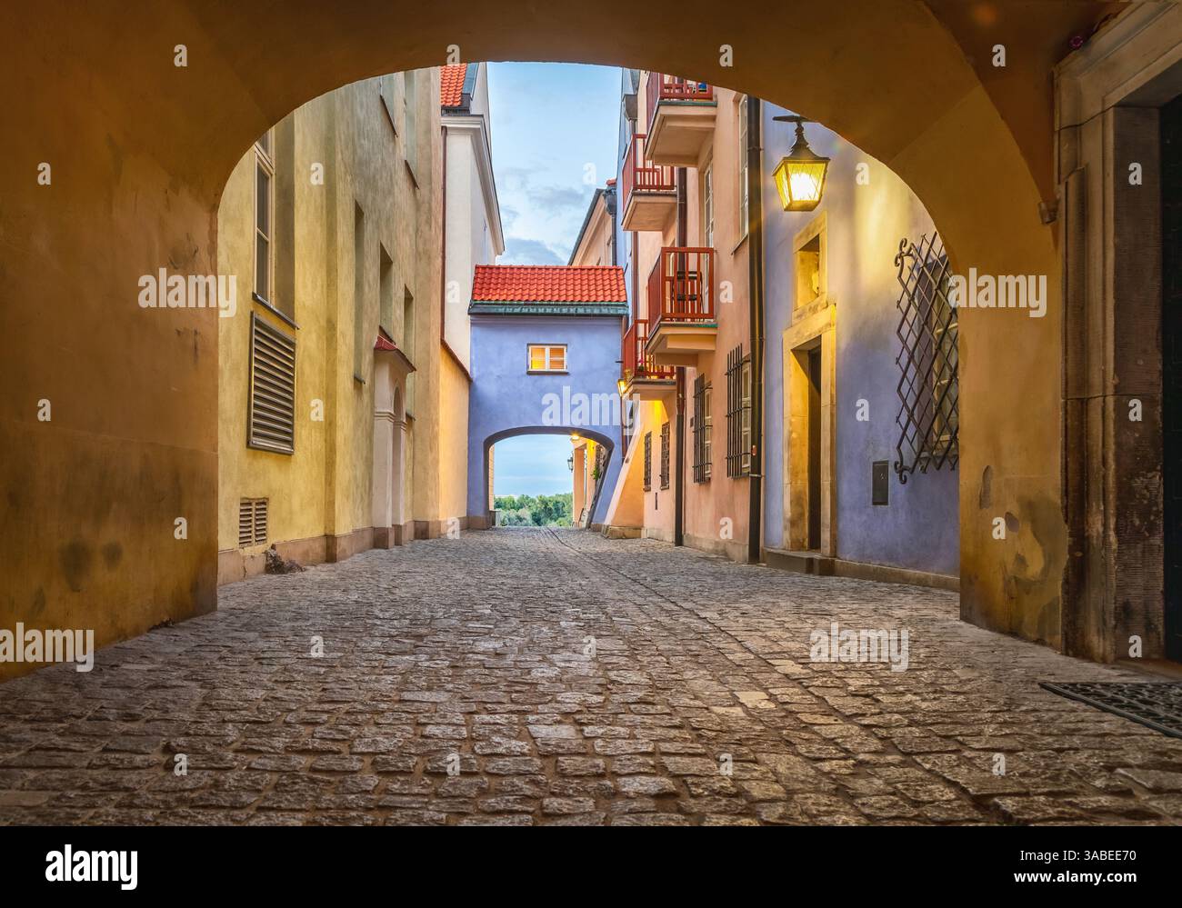Warsaw Old Town. HDR view of narrow street with arch gate at dusk Stock ...