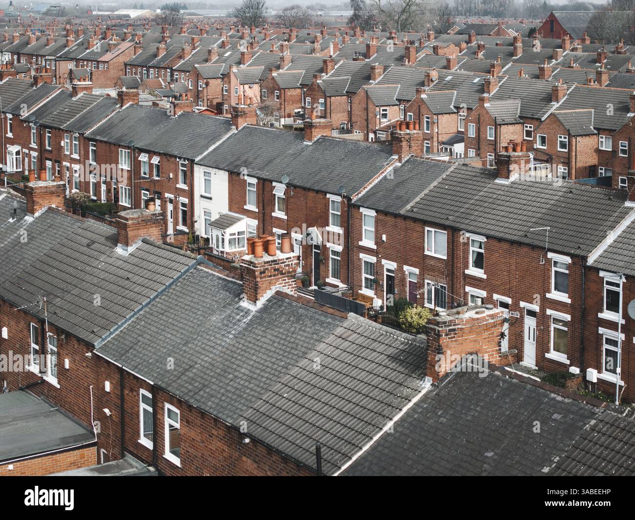 An aerial view above the rooftops of run down back to back terraced ...