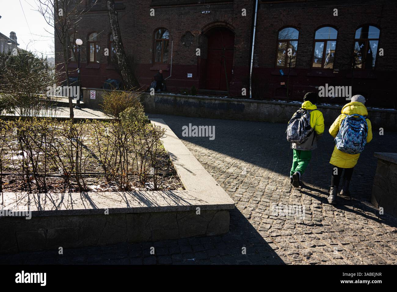 Lviv, Ukraine - April 01, 2025: Two children carrying backpacks ...