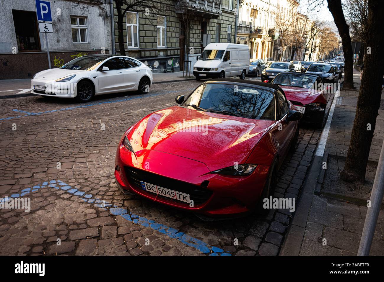 Lviv, Ukraine - April 01, 2025: A red sports car Mazda MX-5 and white ...
