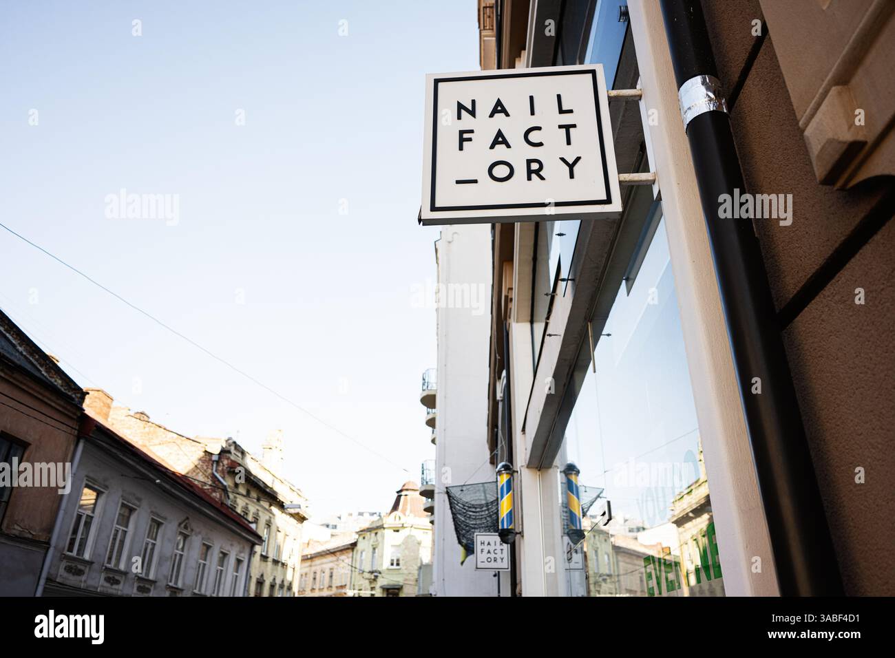 Lviv, Ukraine - April 01, 2025: A beauty salon nail factory sign placed ...