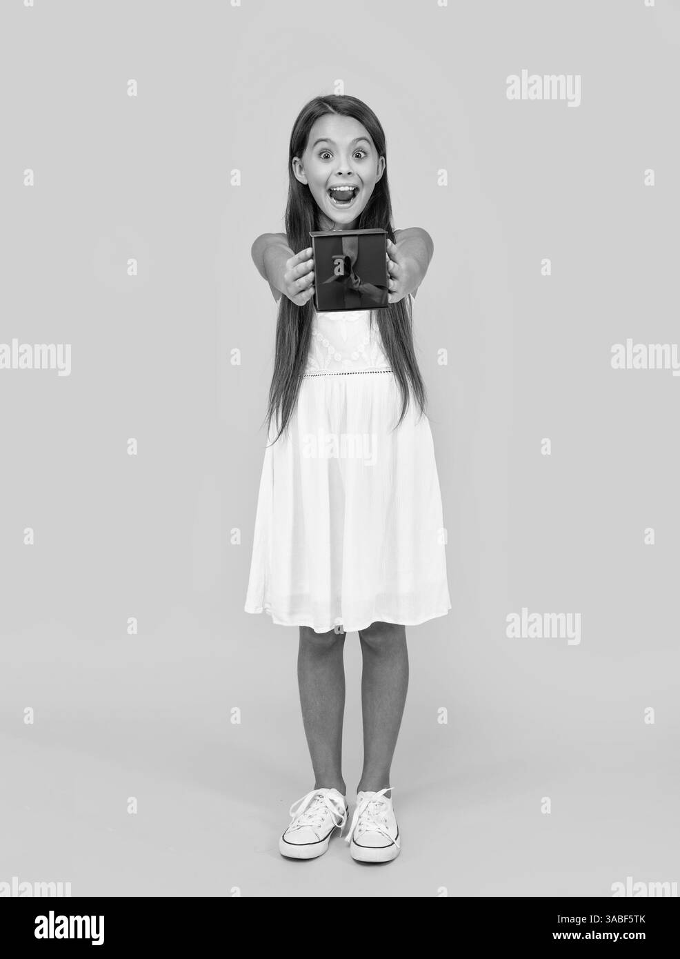 Happy child holding present Black and White Stock Photos & Images - Alamy