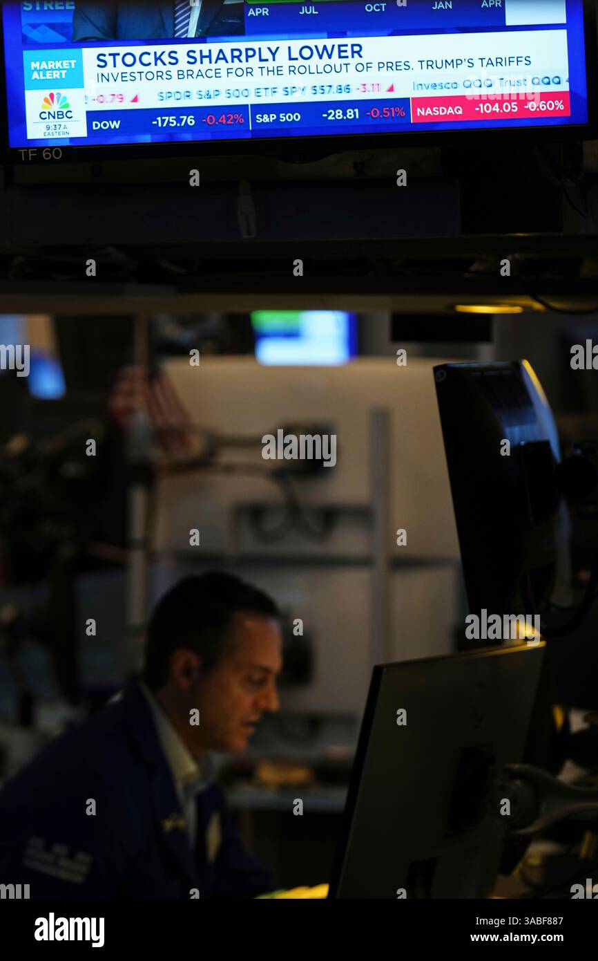 Traders work on the floor at the New York Stock Exchange in New York ...